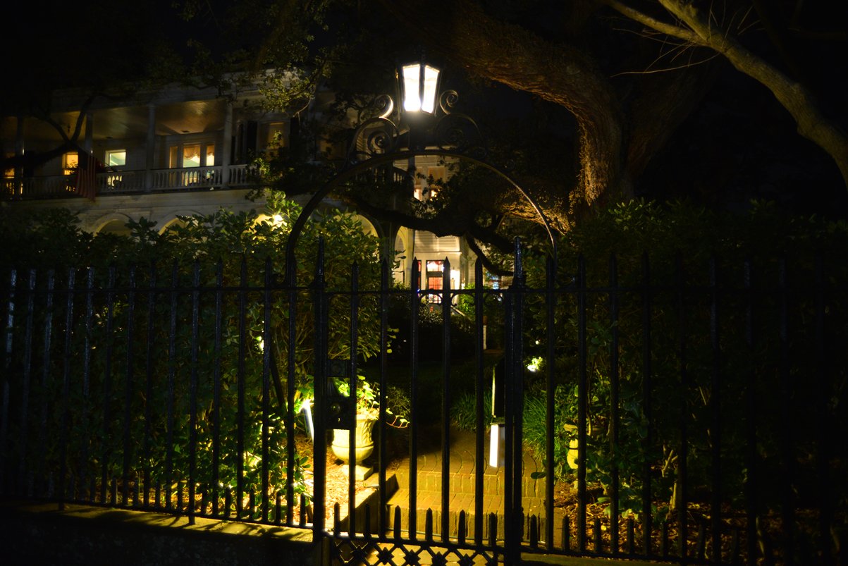Late Night View Through The Lighted Back Gate Of A Historic Home In The ...